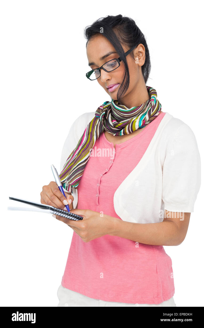 Concentrated cool woman writing in notepad Stock Photo - Alamy