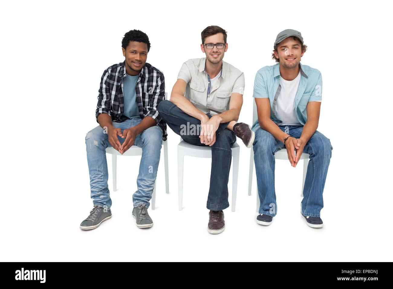 Portrait of three cool young men sitting on chairs Stock Photo - Alamy