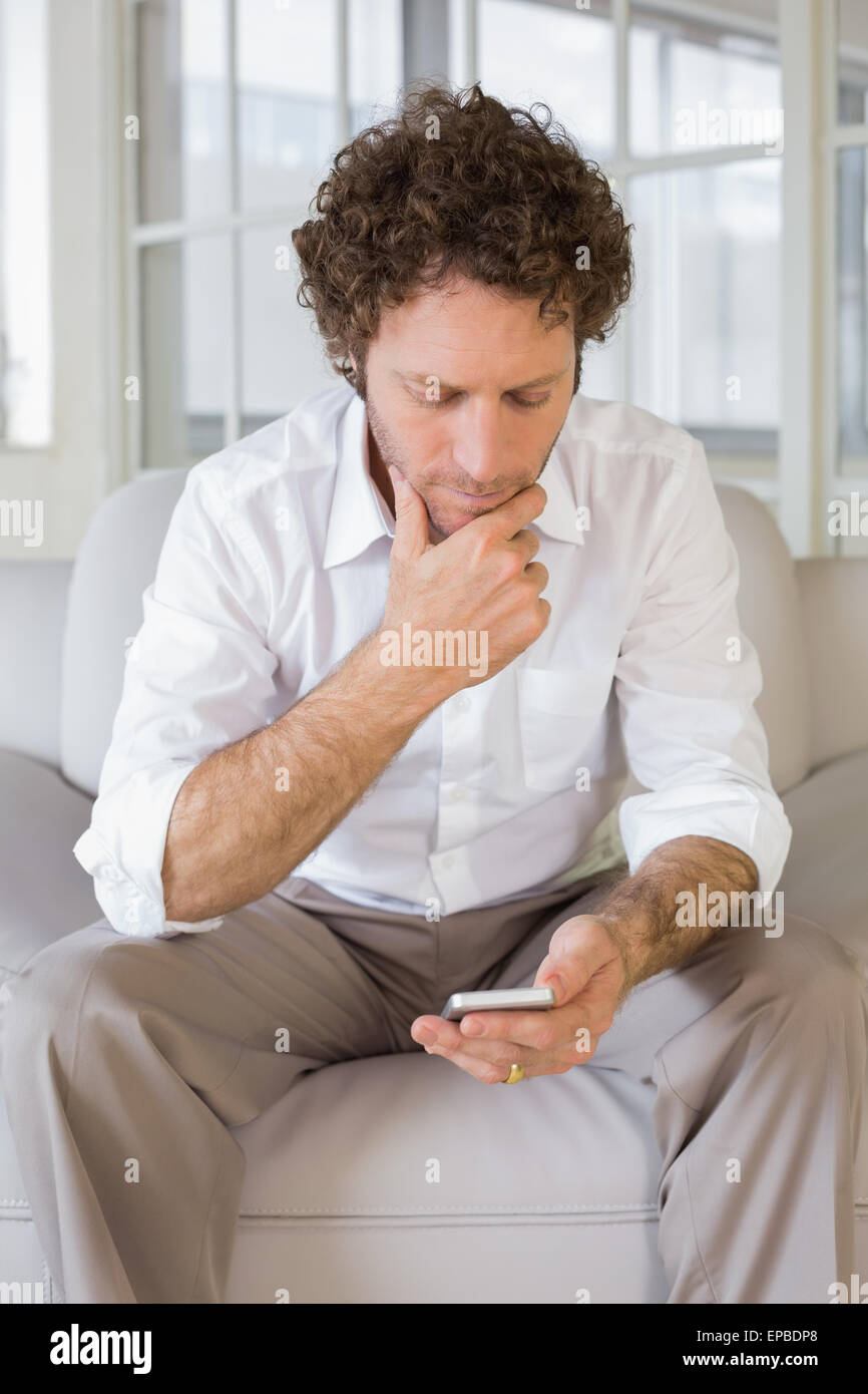 Relaxed man text messaging at home Stock Photo - Alamy