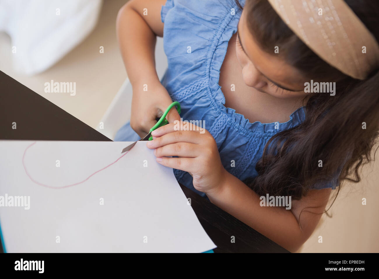 High angle close-up of a girl cutting chart paper Stock Photo - Alamy