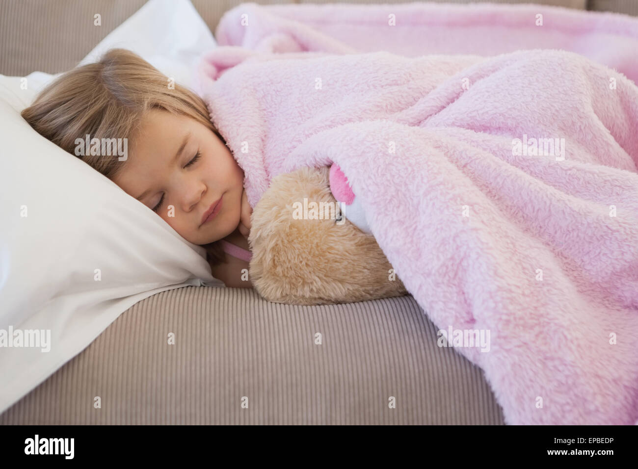 Close-up of a girl sleeping on sofa with stuffed toy Stock Photo - Alamy