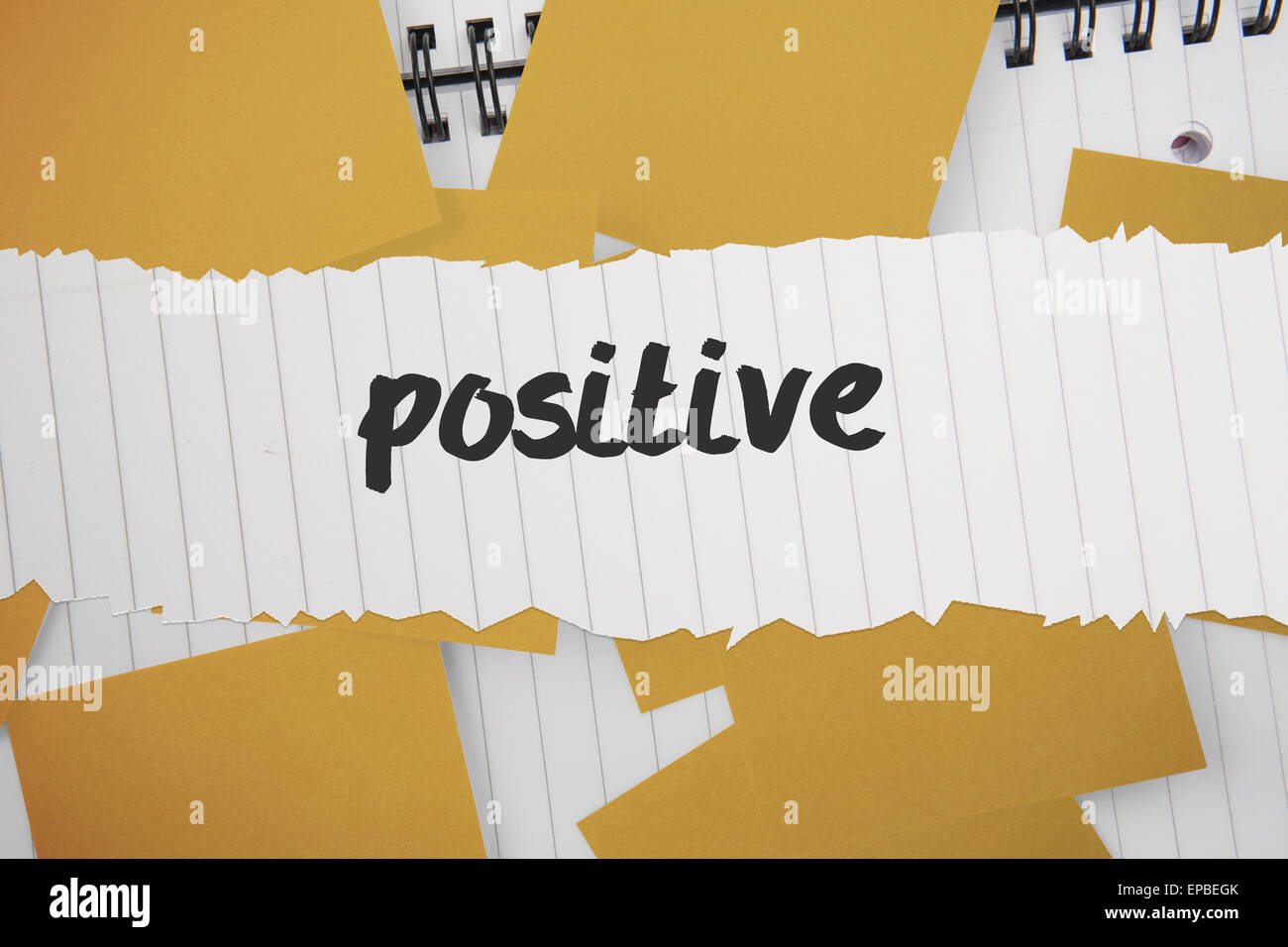 Positive against yellow paper strewn over notepad Stock Photo - Alamy
