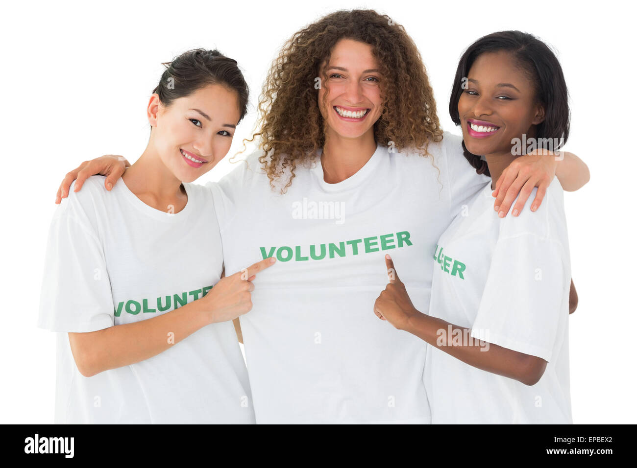 Attractive team of volunteers smiling at camera Stock Photo - Alamy