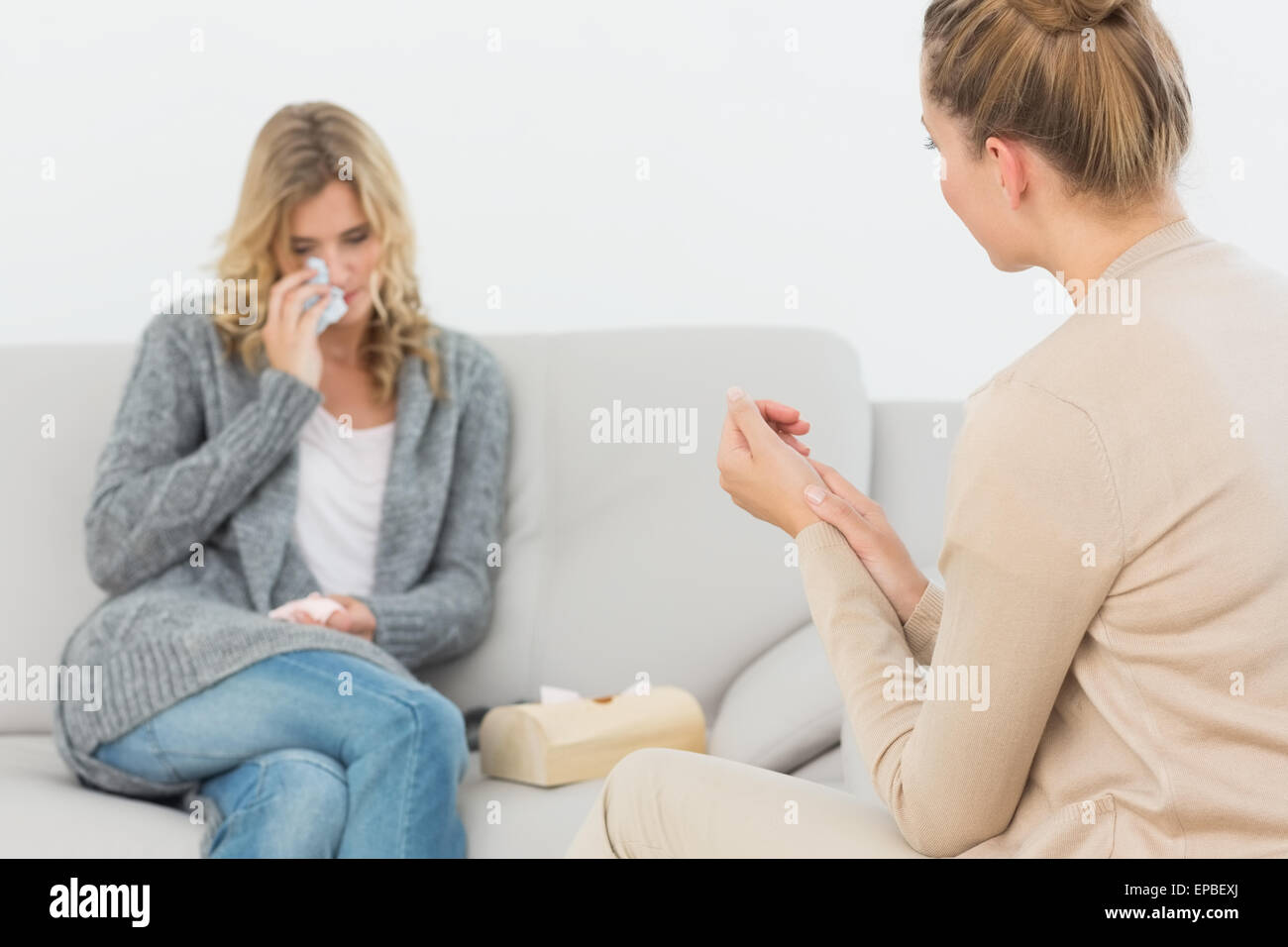 Therapist listening to crying patient on the sofa Stock Photo - Alamy