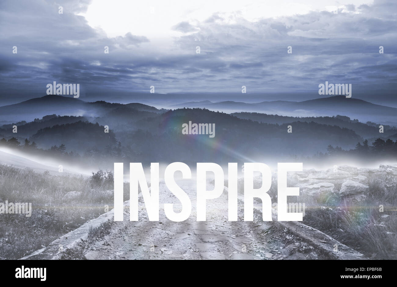 The word inspire against stony path leading to large misty mountains ...