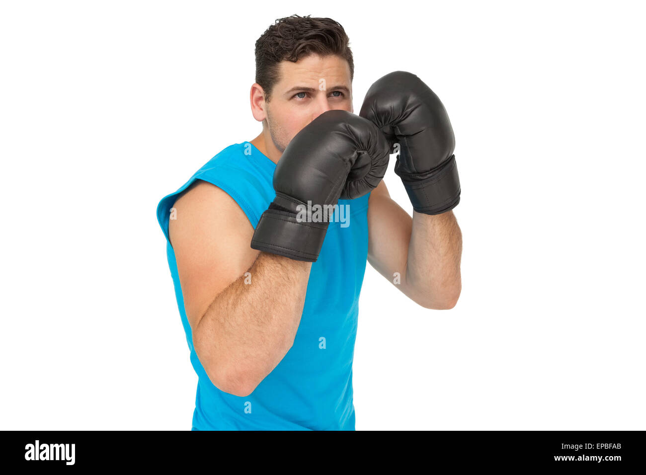 Determined male boxer focused on his training over white background ...