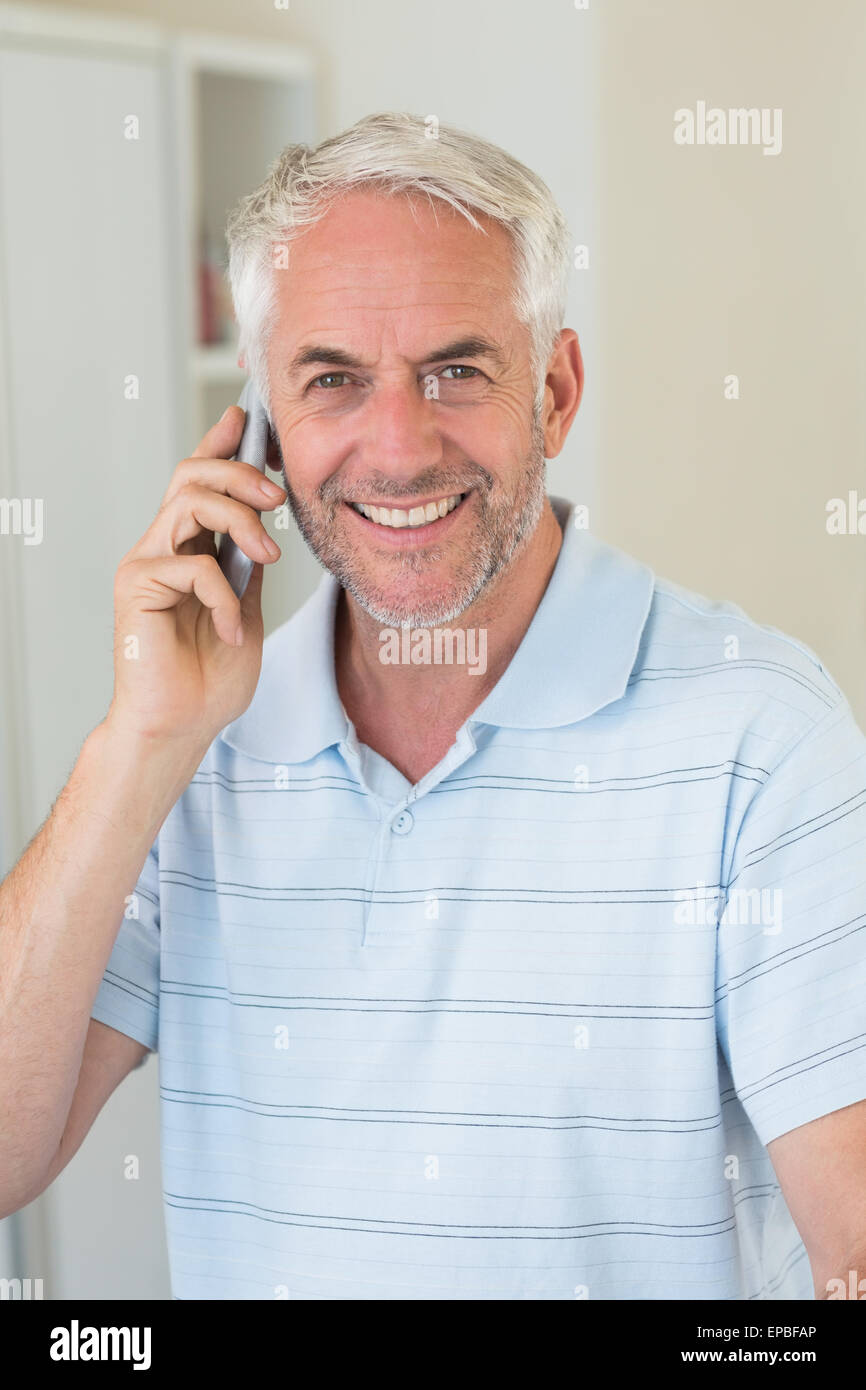 Smiling man on a phone call looking at camera Stock Photo - Alamy