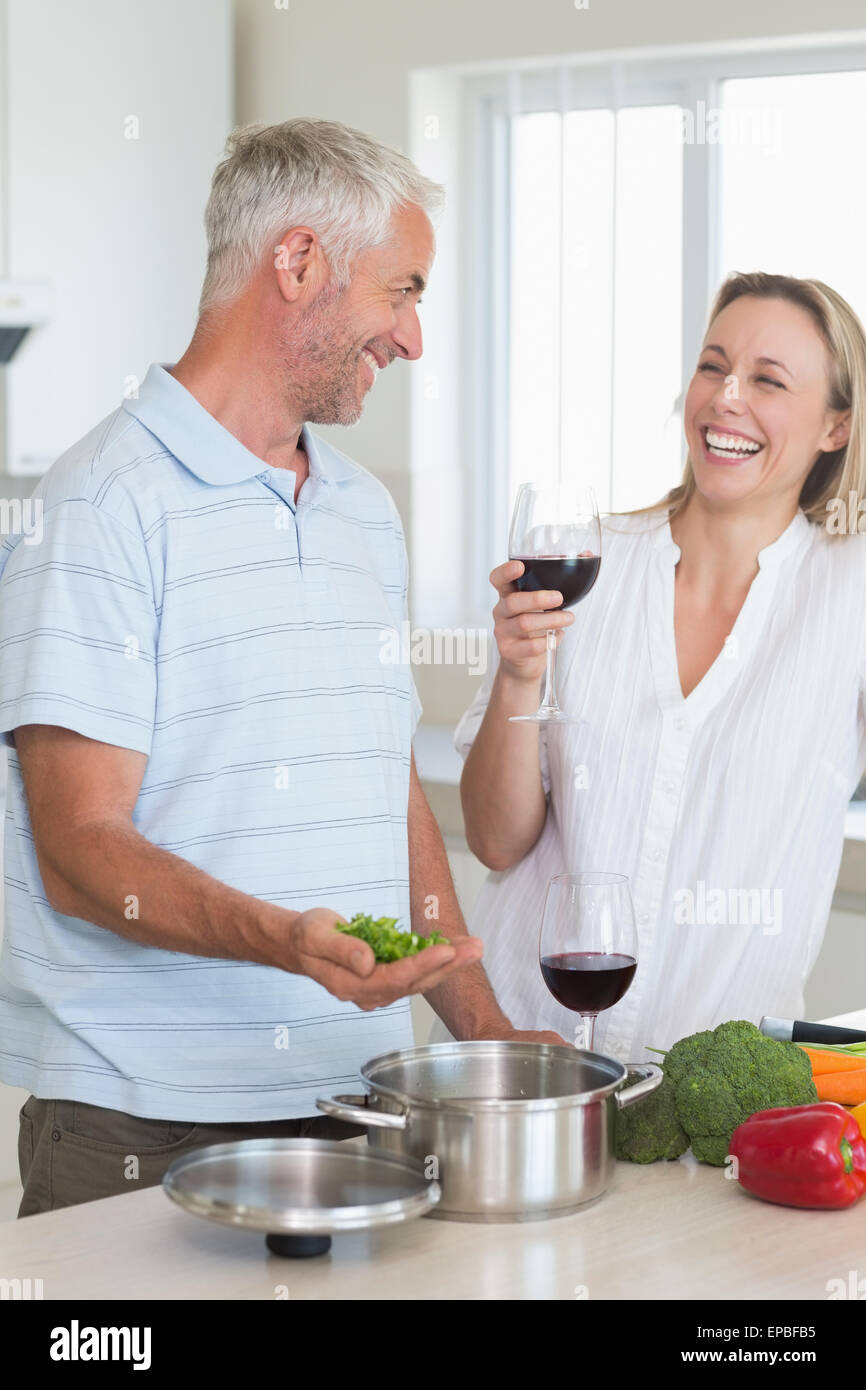 Laughing couple making dinner together Stock Photo - Alamy