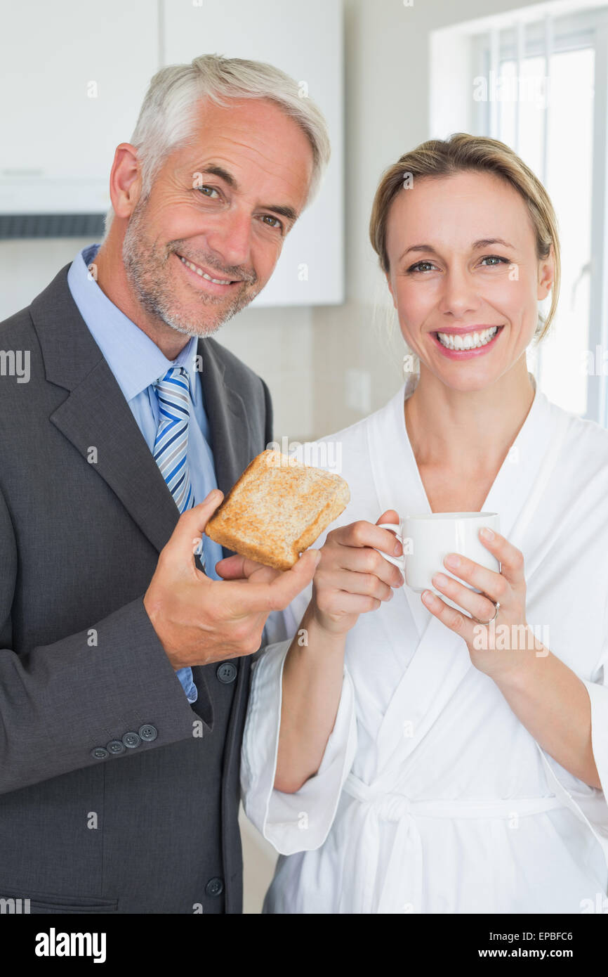 Smiling couple having breakfast in the morning before work Stock Photo ...