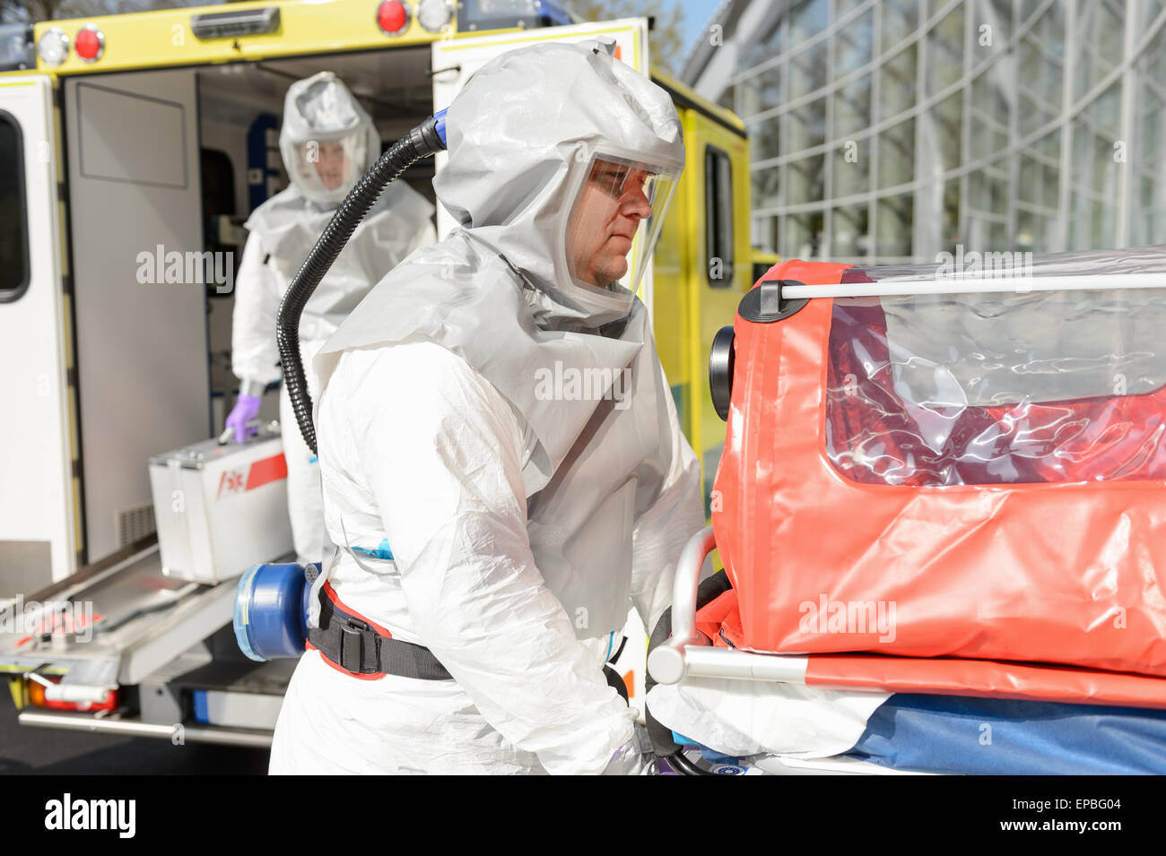 Biohazard medical team member with stretcher Stock Photo - Alamy