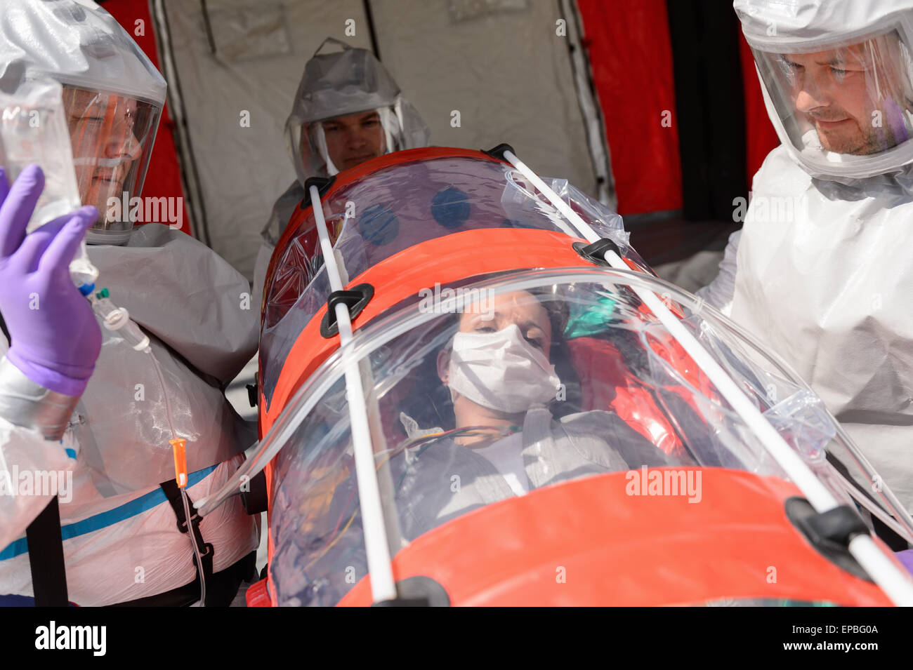 HAZMAT team with patient on stretcher Stock Photo - Alamy