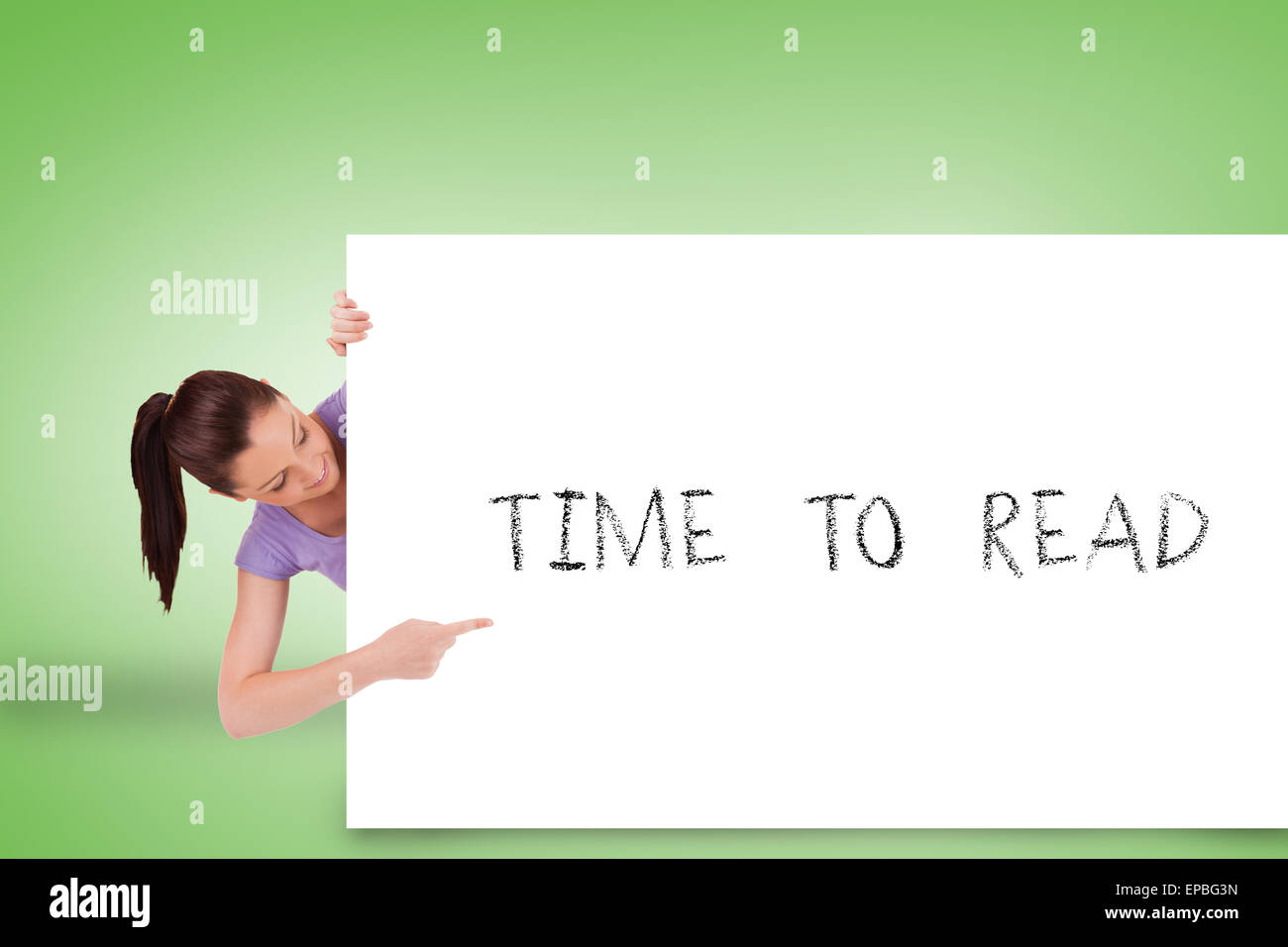 Pretty brunette showing card with time to read Stock Photo - Alamy