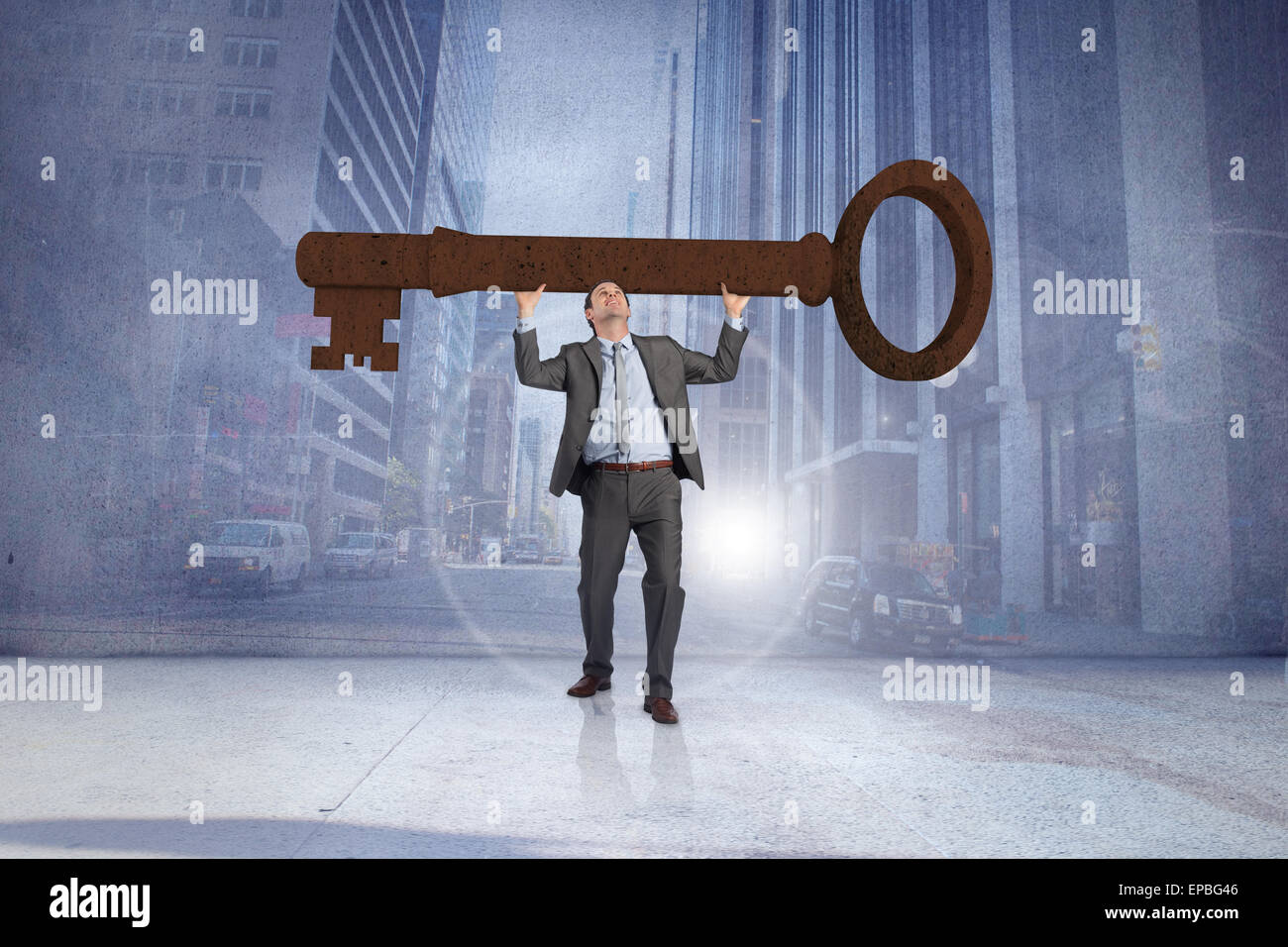 Composite image of businessman carrying large key Stock Photo - Alamy