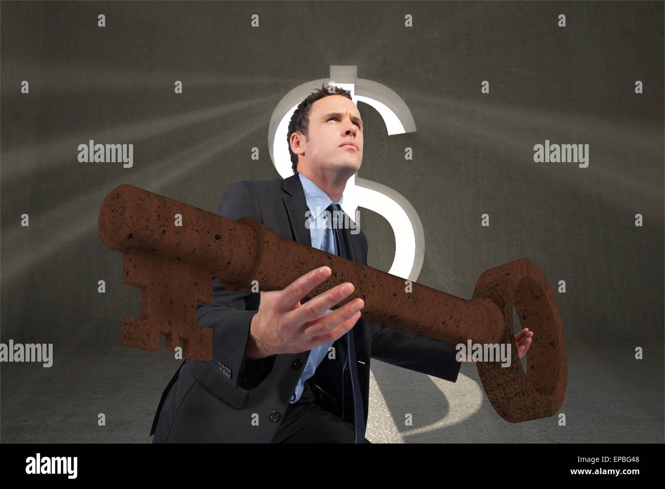 Unsmiling businessman carrying large key with arms raised against door ...