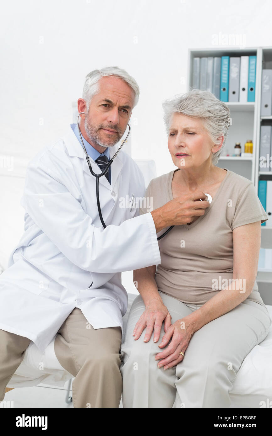 Doctor checking patients heartbeat using stethoscope Stock Photo - Alamy