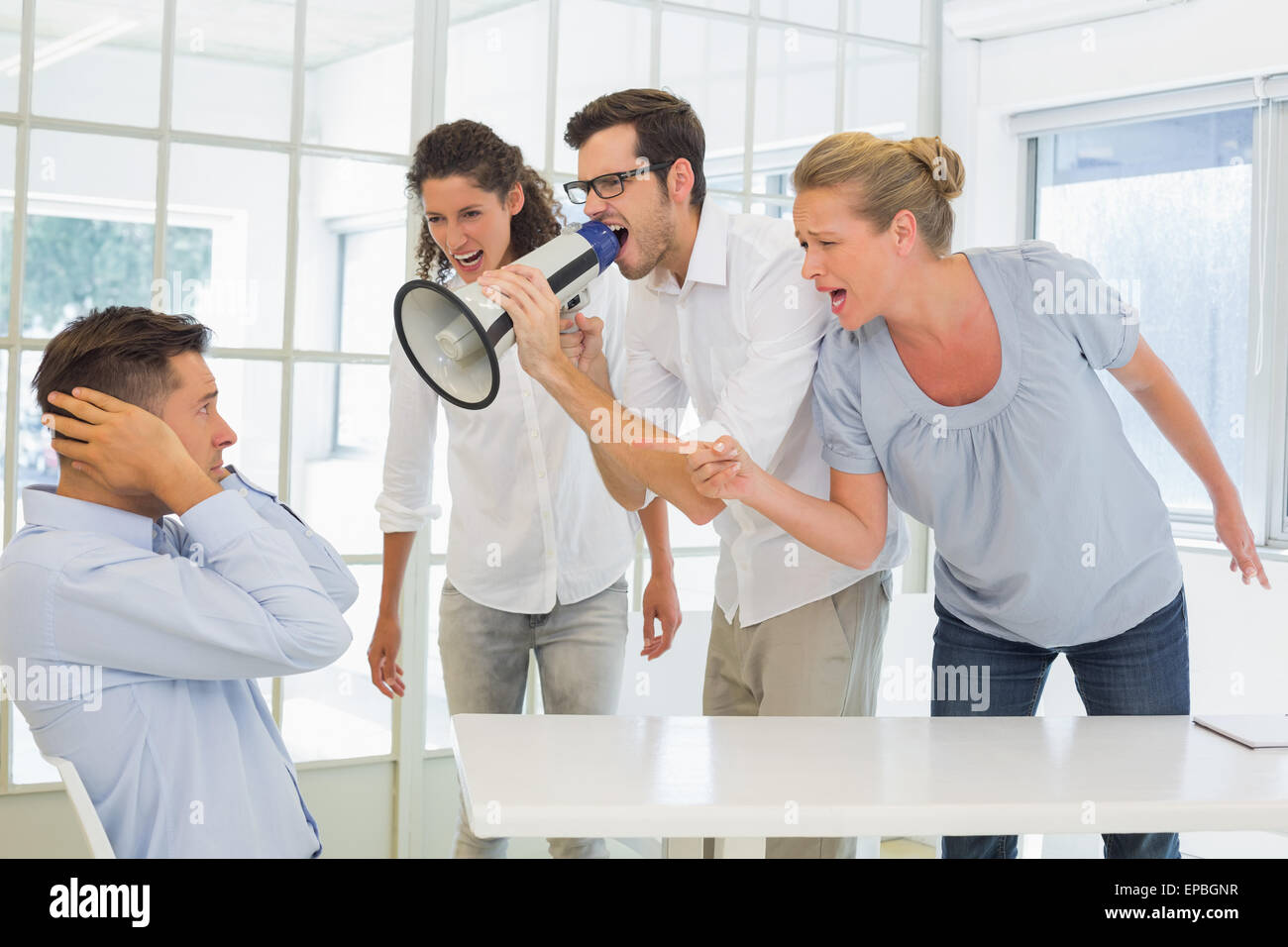 Casual business team shouting at a colleague Stock Photo - Alamy