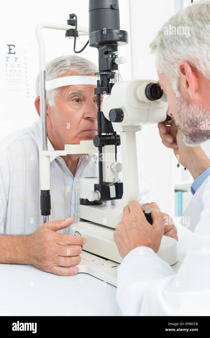 Optometrist doing sight testing for senior patient Stock Photo - Alamy