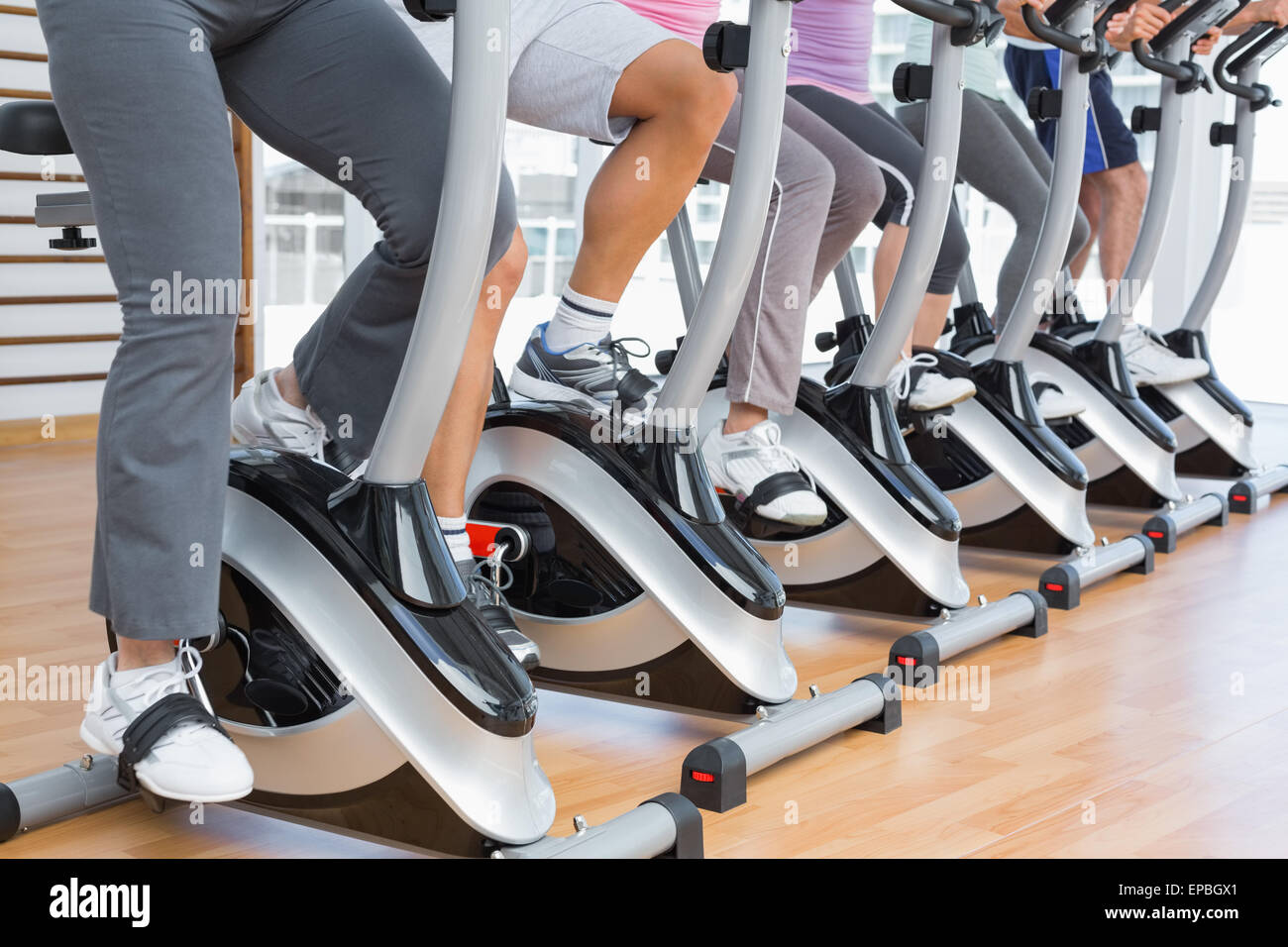 Low section of people working out at spinning class Stock Photo - Alamy