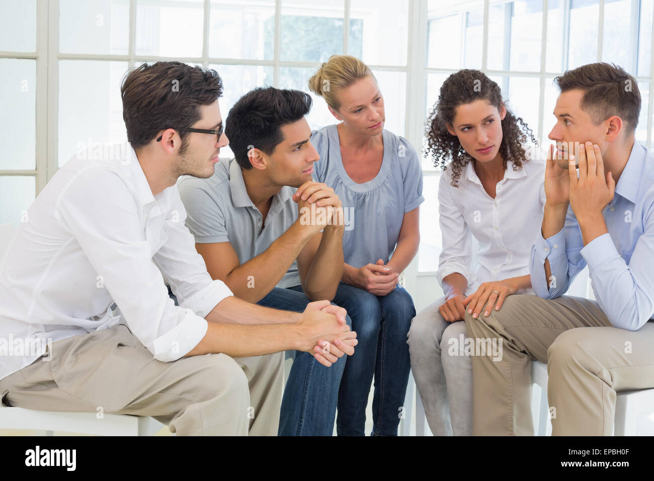 Group therapy in session sitting in a circle Stock Photo - Alamy