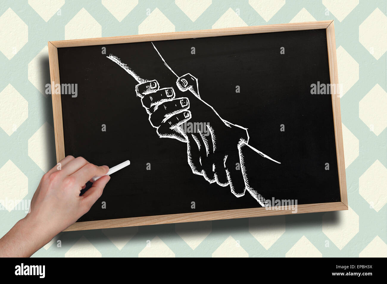 Composite image of hand drawing handshake with chalk Stock Photo - Alamy