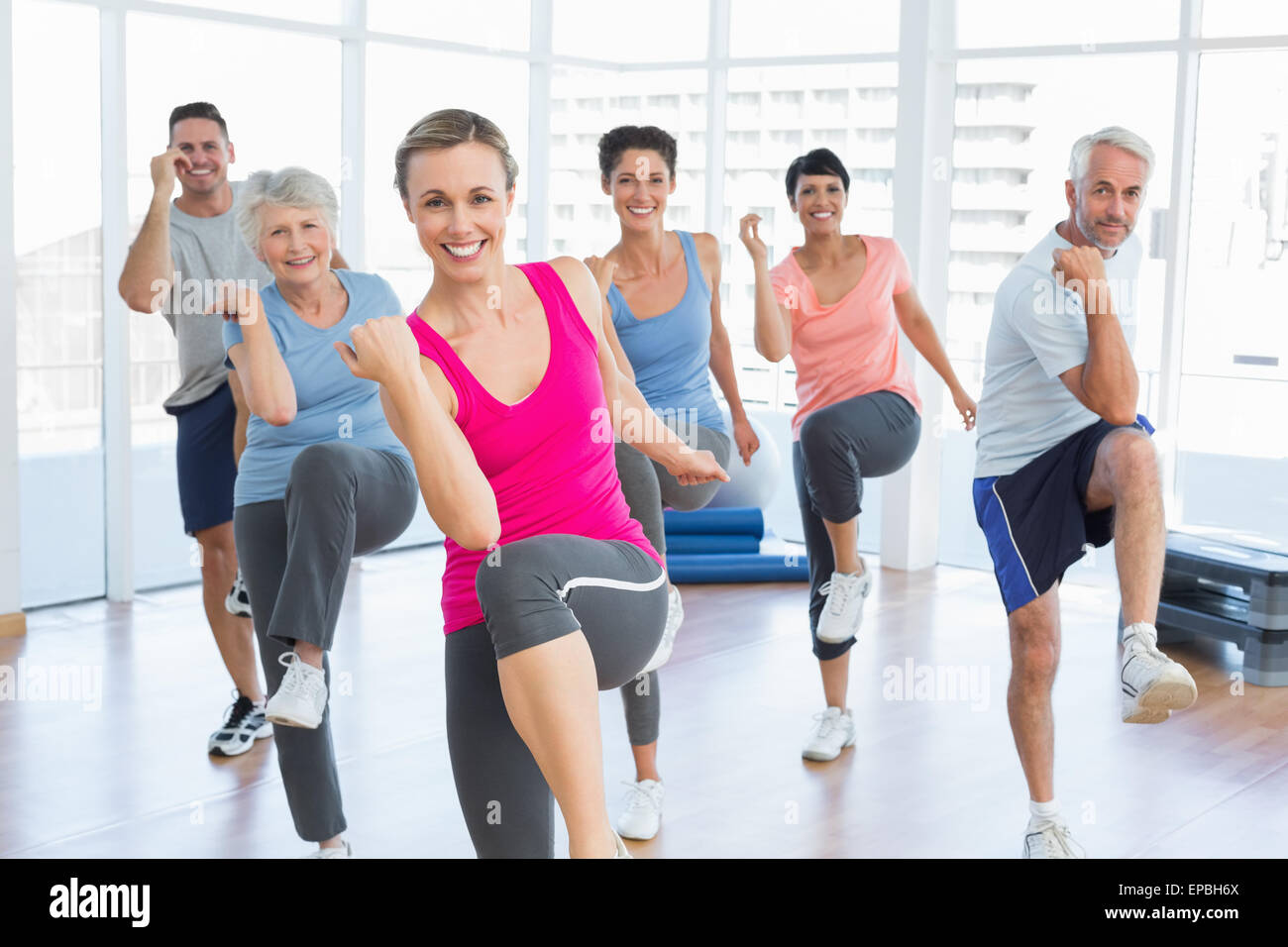 Smiling people doing power fitness exercise at yoga class Stock Photo ...