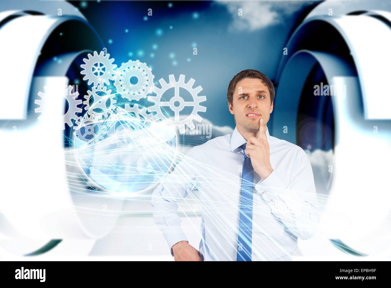 Confused businessman with cogs and wheels graphics Stock Photo - Alamy