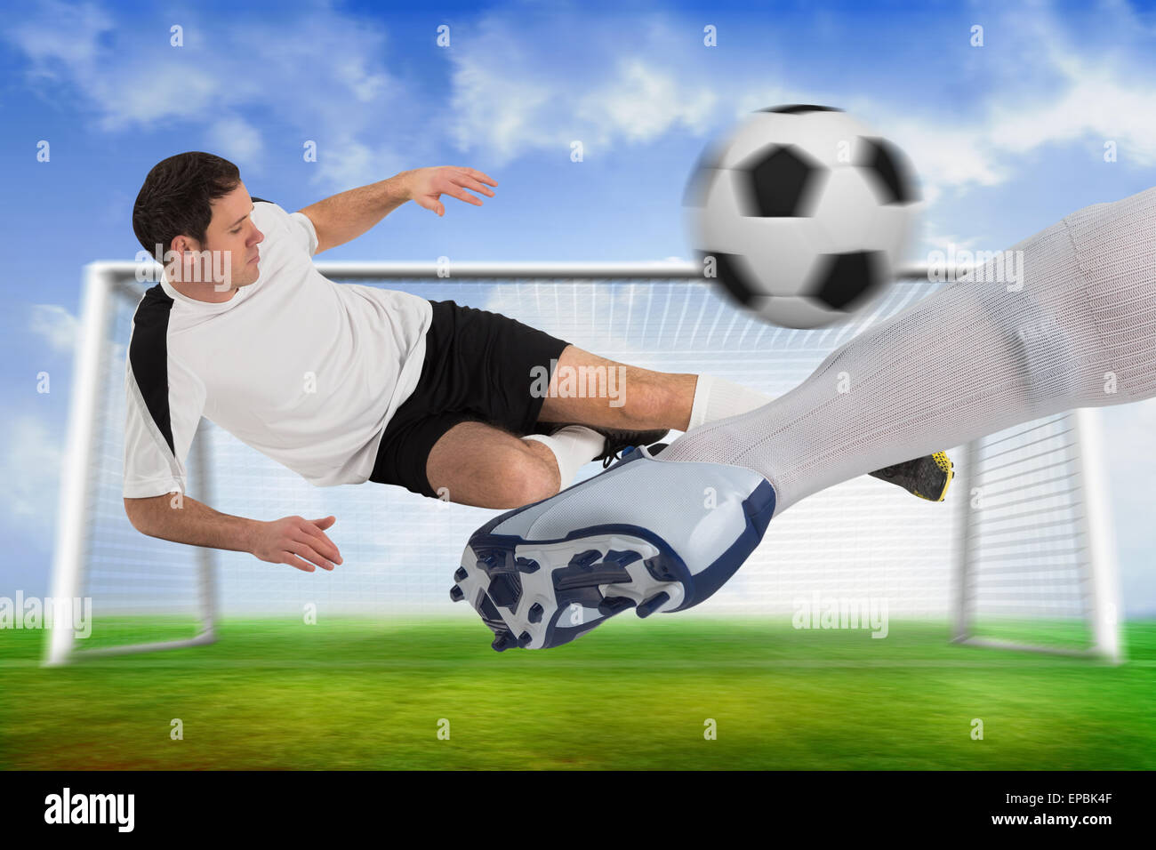 Football players tackling for the ball Stock Photo - Alamy