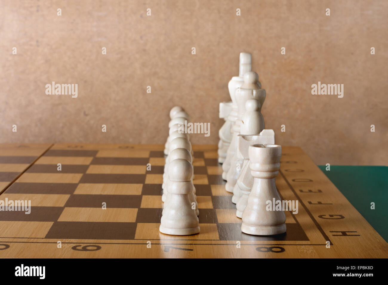 Wooden chess board with figures on table and old wall Stock Photo - Alamy