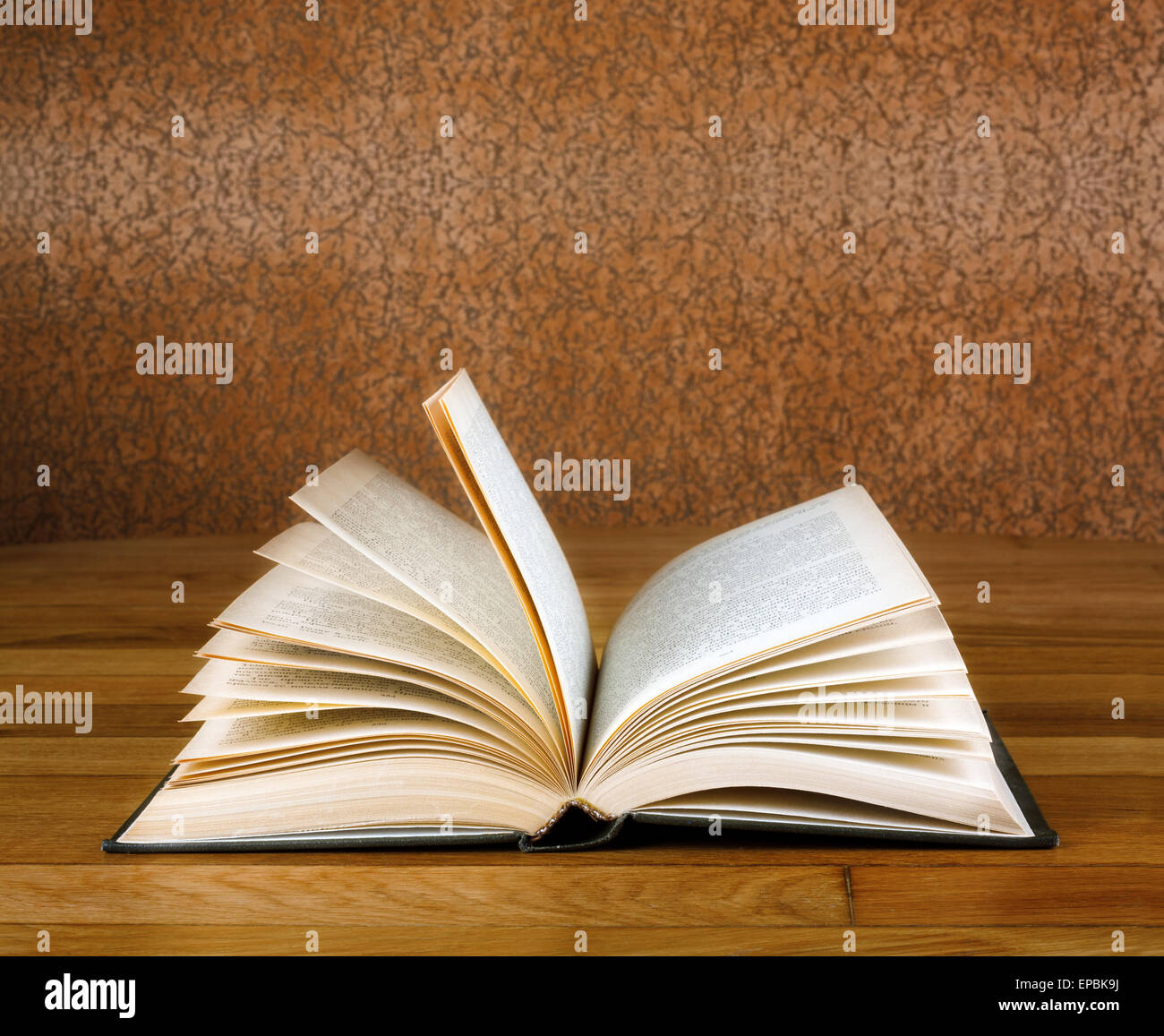 Old open book on grunge wooden table Stock Photo - Alamy