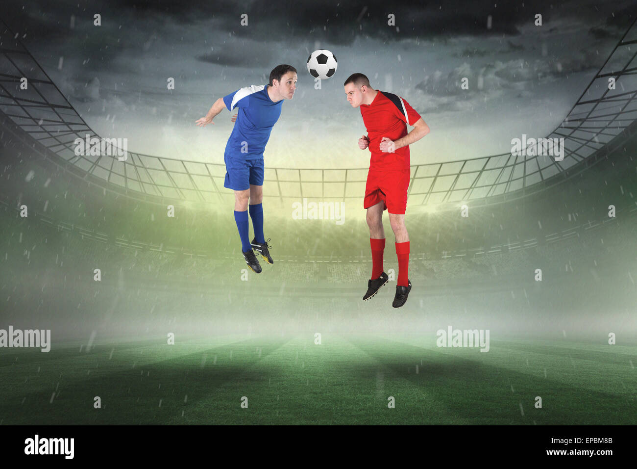Football players tackling for the ball Stock Photo - Alamy