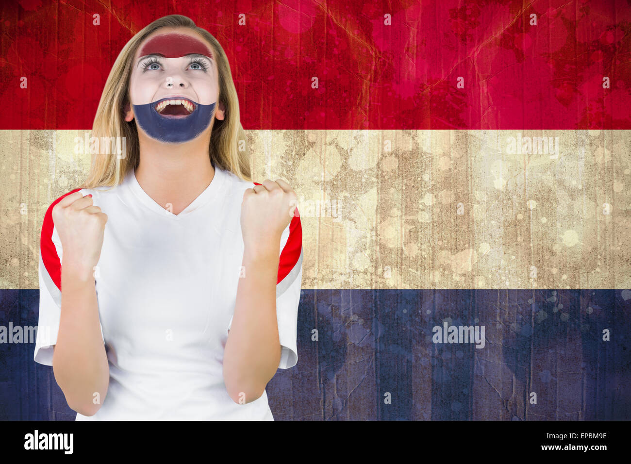 Excited netherlands fan in face paint cheering Stock Photo - Alamy