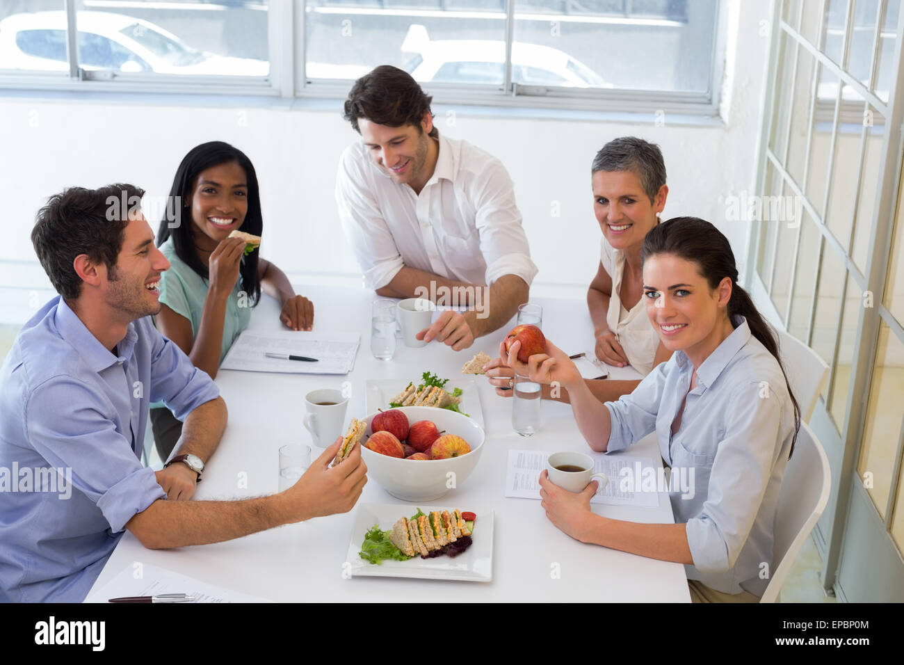 Workers enjoying sandwiches for lunch Stock Photo - Alamy