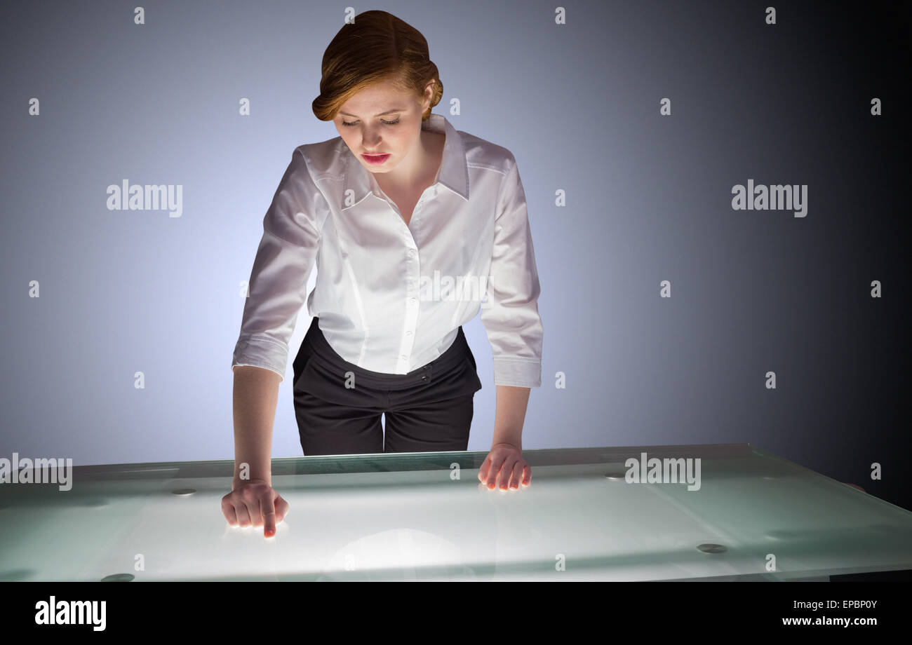 Redhead businesswoman standing and pointing on desk Stock Photo - Alamy