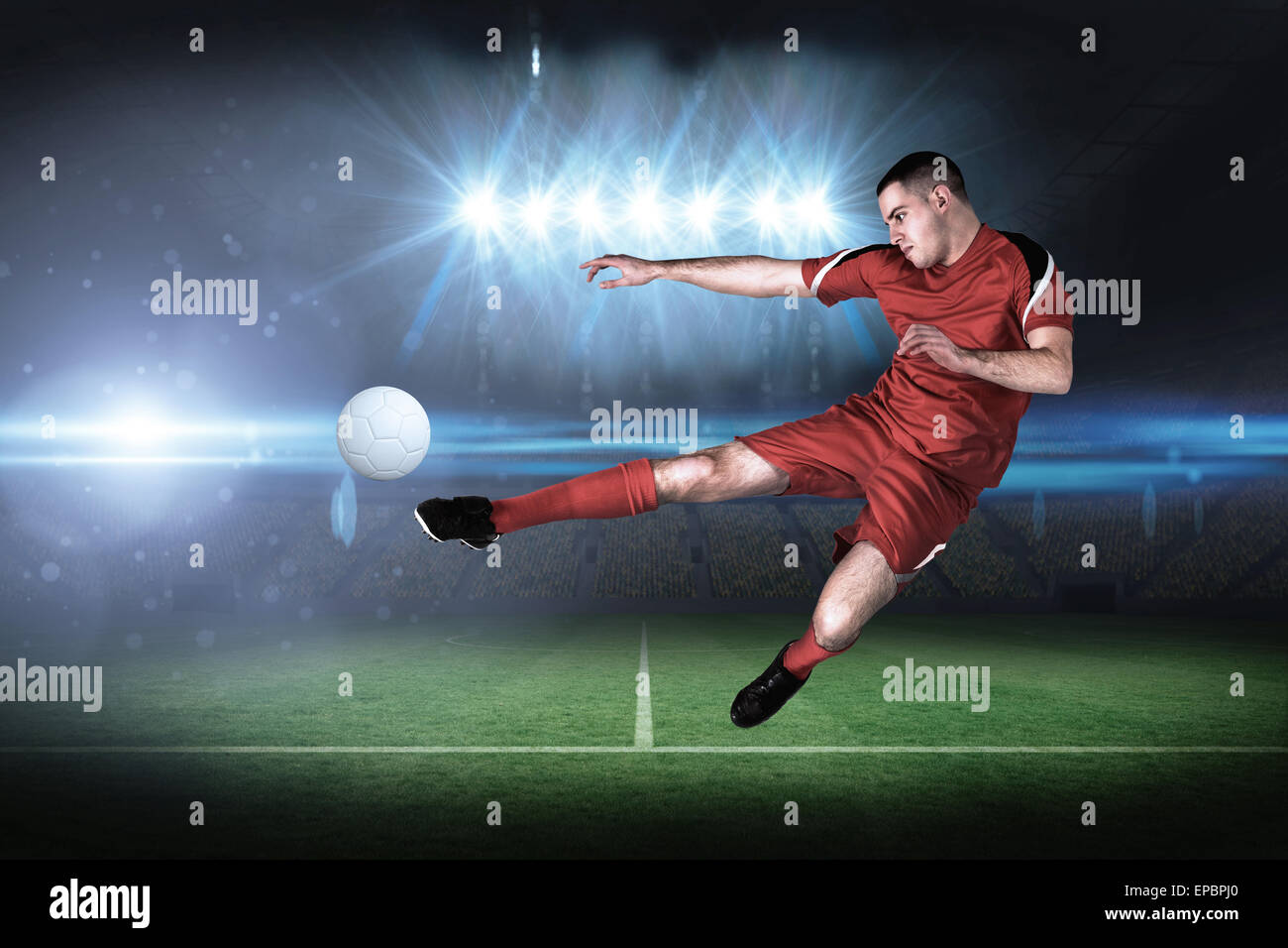 Fit football player playing and kicking Stock Photo - Alamy