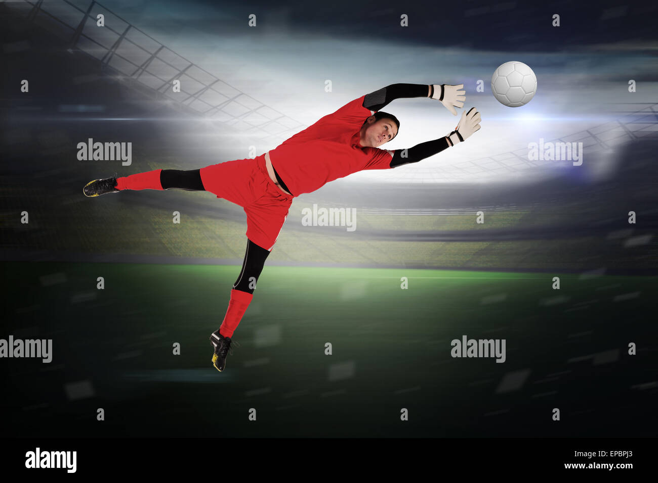 Fit goal keeper jumping up Stock Photo - Alamy