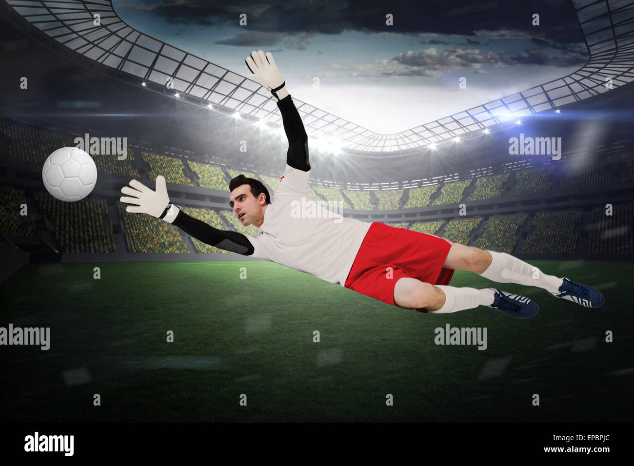 Goalkeeper in white making a save Stock Photo - Alamy