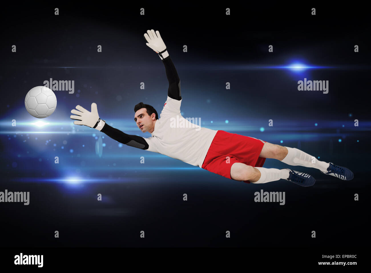Goalkeeper in white making a save Stock Photo - Alamy