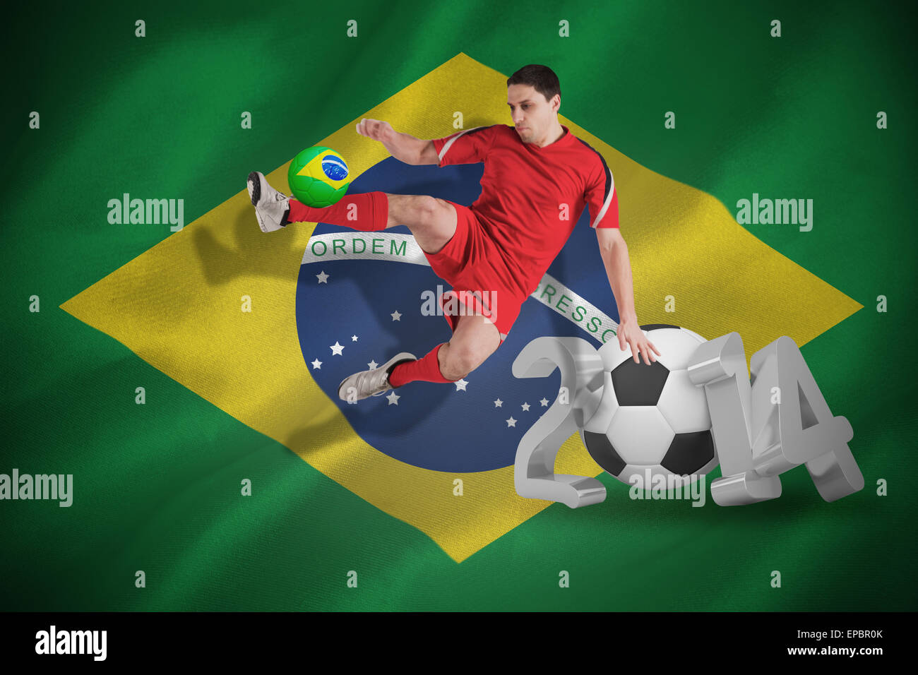 Fit football player jumping and kicking Stock Photo - Alamy