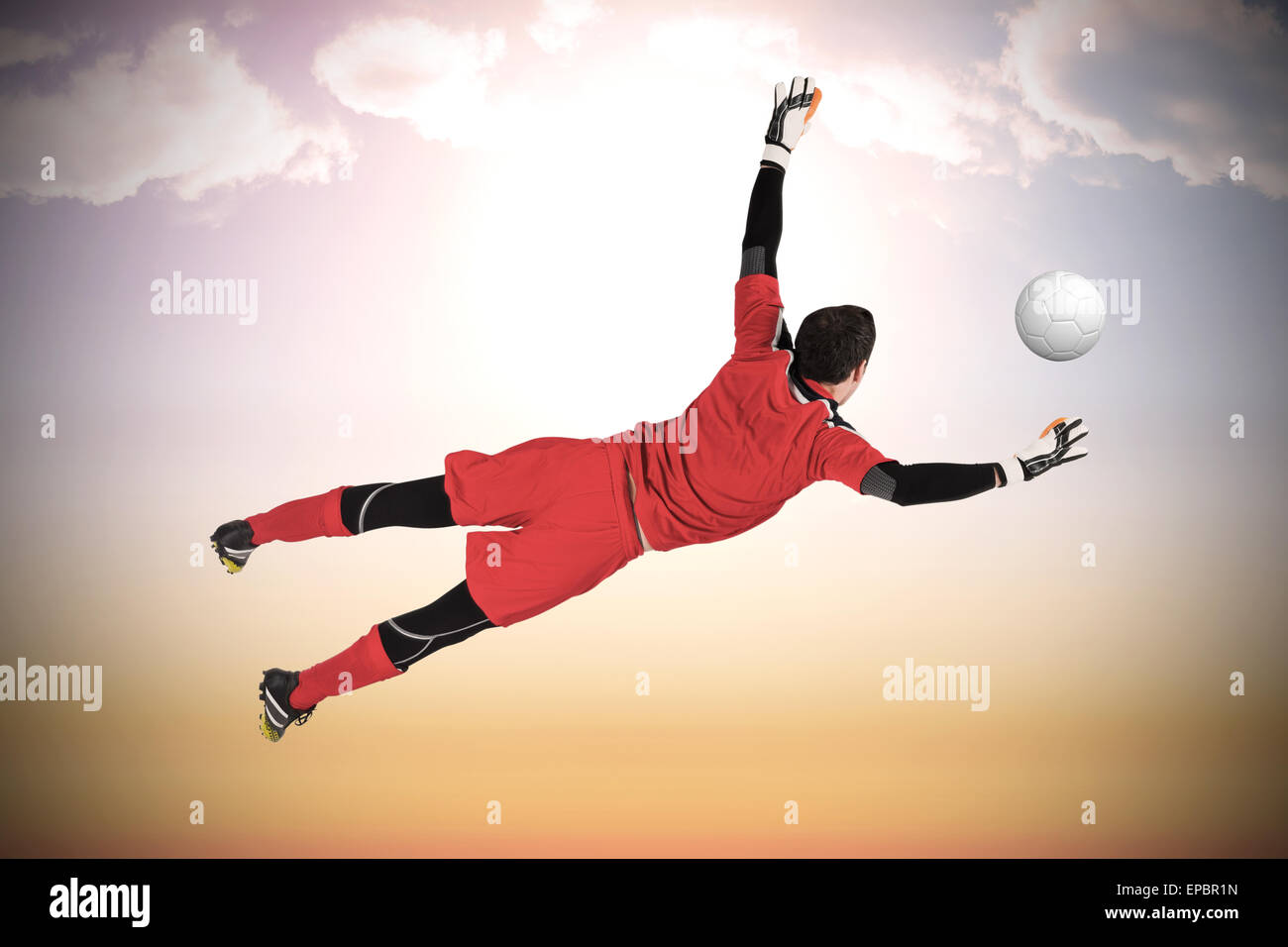 Fit goal keeper jumping up Stock Photo - Alamy