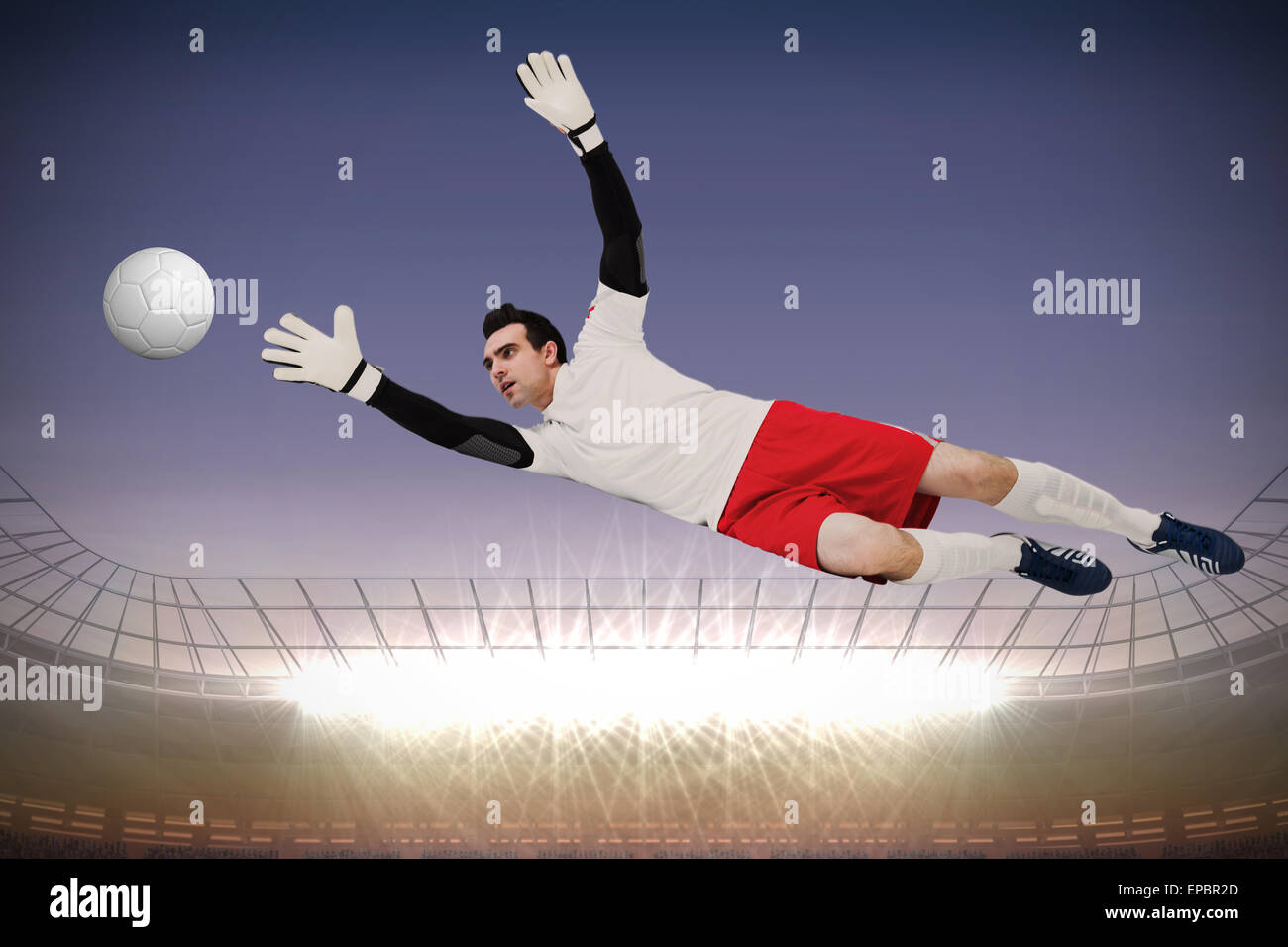 Goalkeeper in white making a save Stock Photo - Alamy