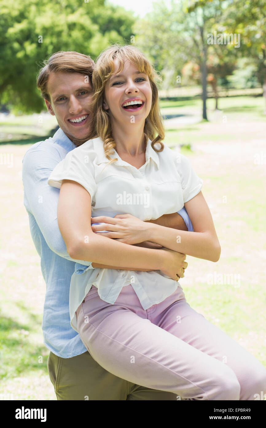 Handsome man picking up his laughing girlfriend in the park Stock Photo ...