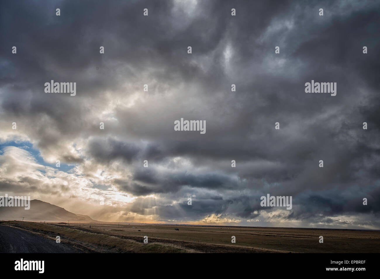 View of storm clouds over field Stock Photo - Alamy