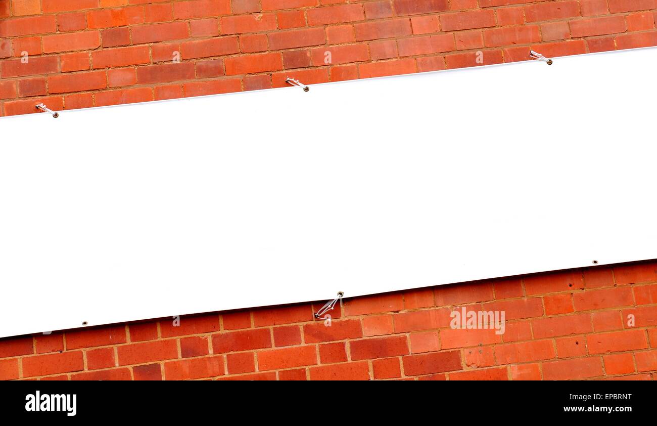 White banner against red brick wall Stock Photo - Alamy
