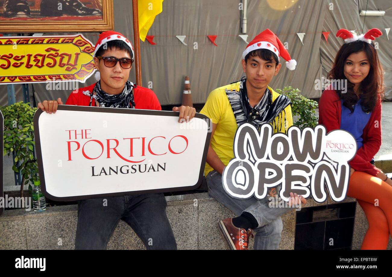 Bangkok, Thailand: A group of young Thais holding advertising signs for ...