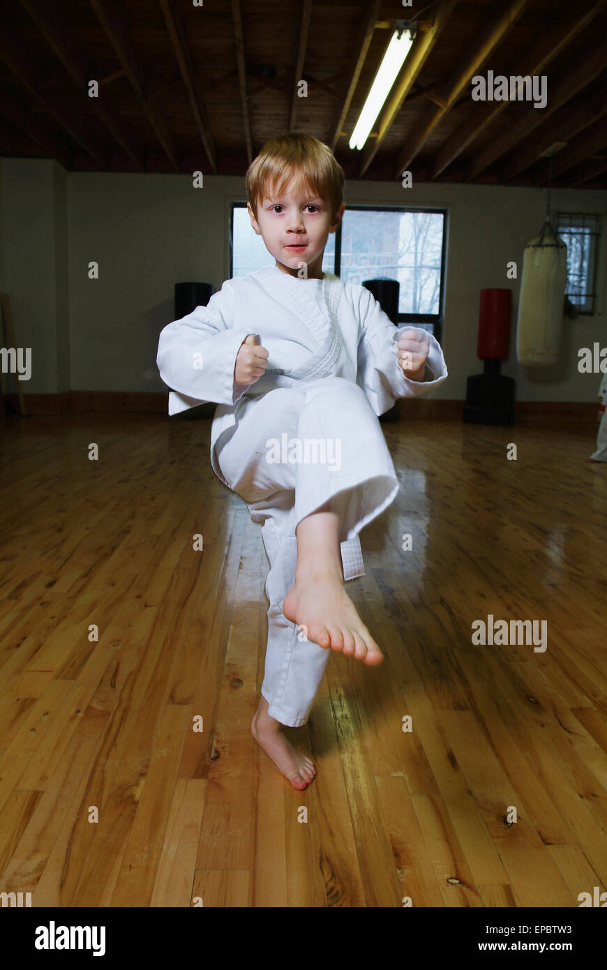 Boy in karate class demonstrating kick Stock Photo - Alamy