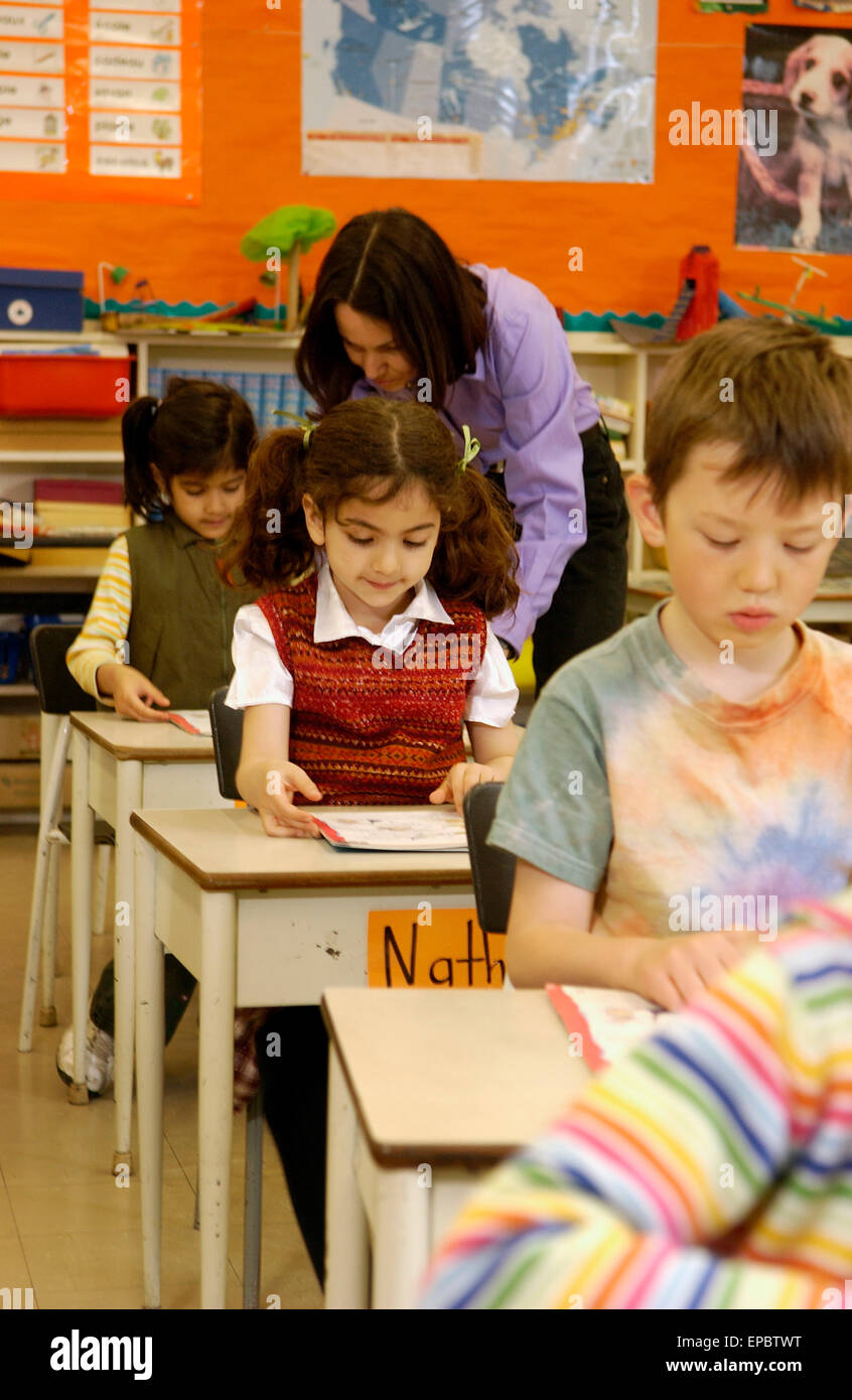 Teacher helping Grade 2 students working in class Stock Photo - Alamy