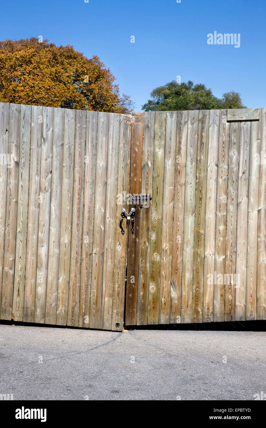 Locked Wooden Gate With Trees Behind Stock Photo - Alamy