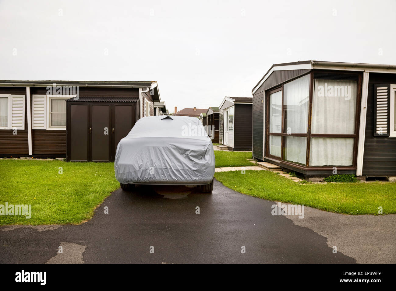Covered Car In A Driveway Stock Photo - Alamy