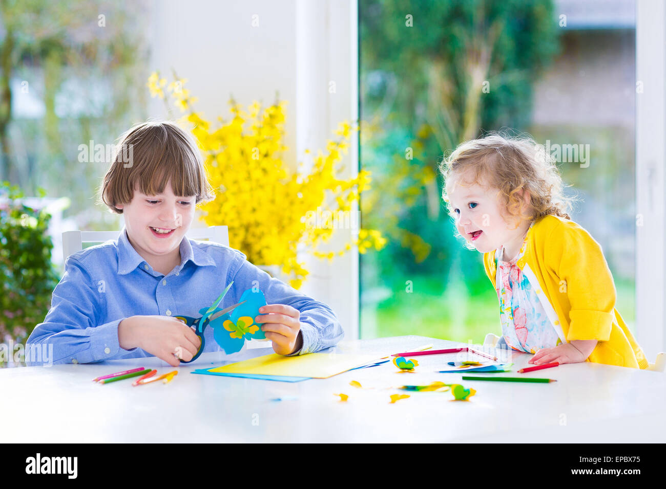 Two happy children, school age boy and little toddler girl having fun ...