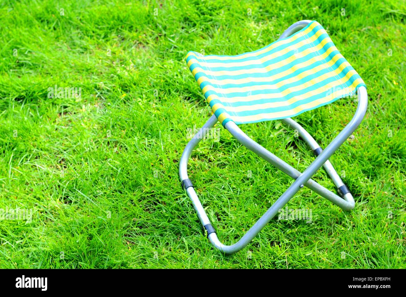 Chair on green grass Stock Photo - Alamy